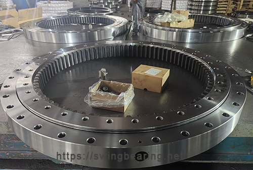 How does the swing bearing interact with other components of the ...